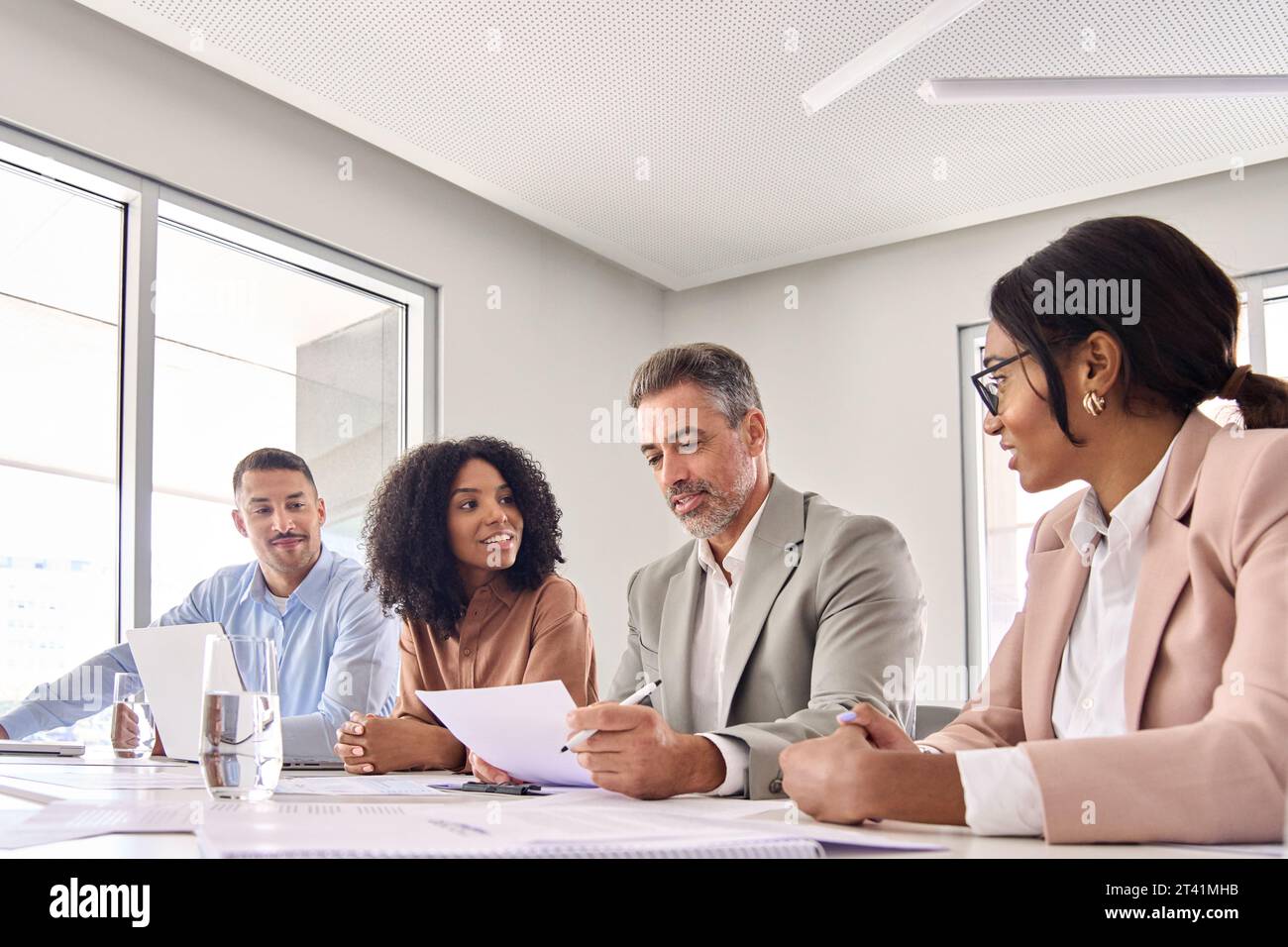 Busy diverse professional business team having discussion at office ...