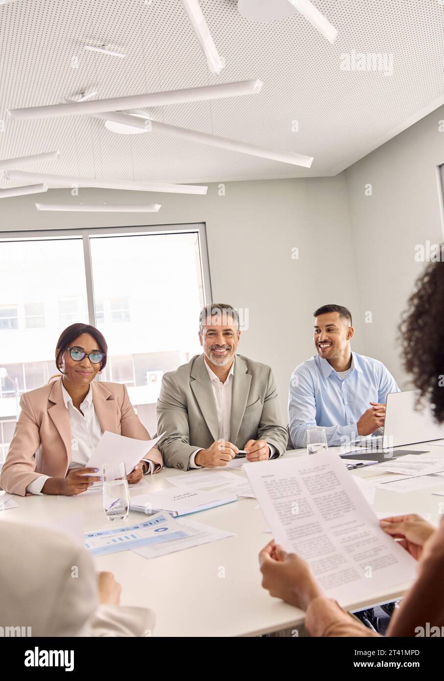 Happy diverse executive board work group talking at office meeting ...