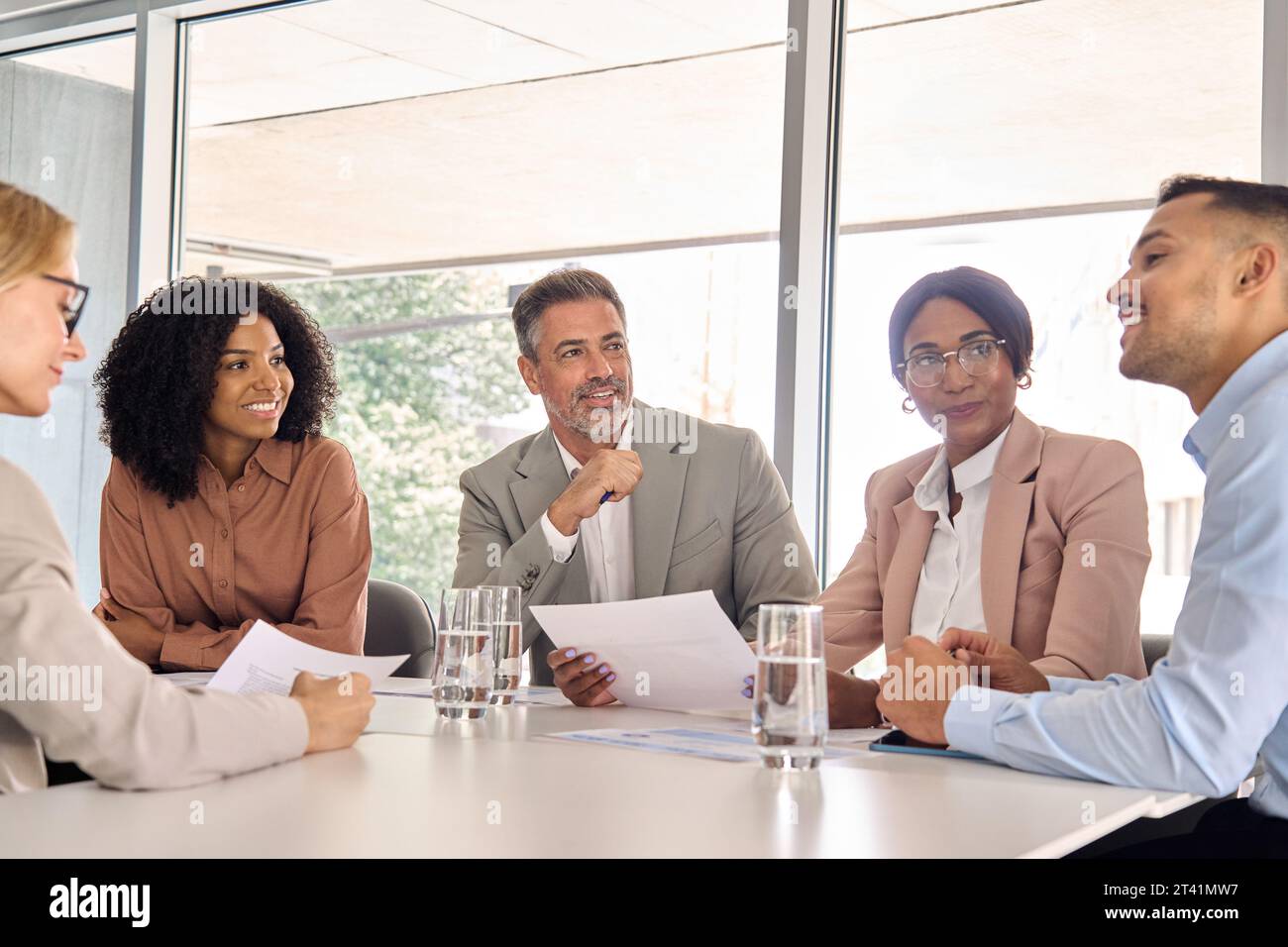 Busy international employees work group having discussion at office ...