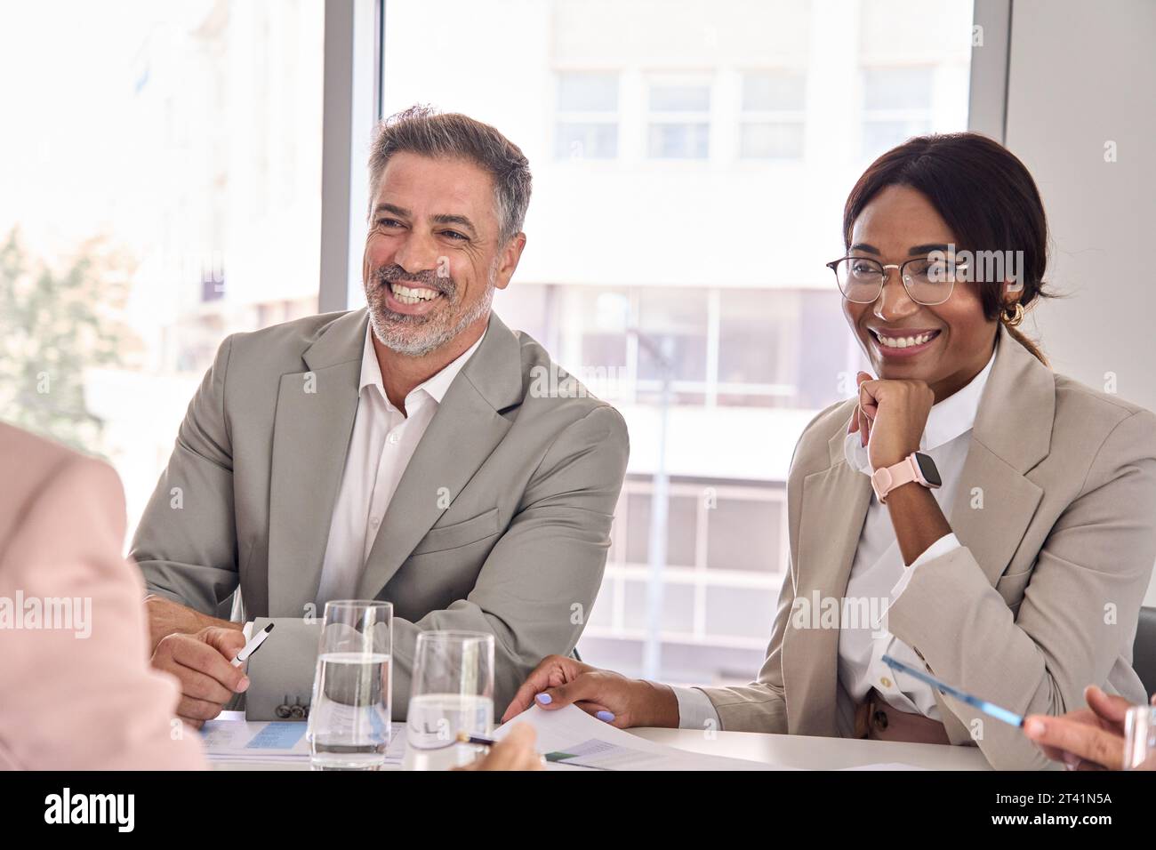 Happy busy diverse executive business people communicating at office ...