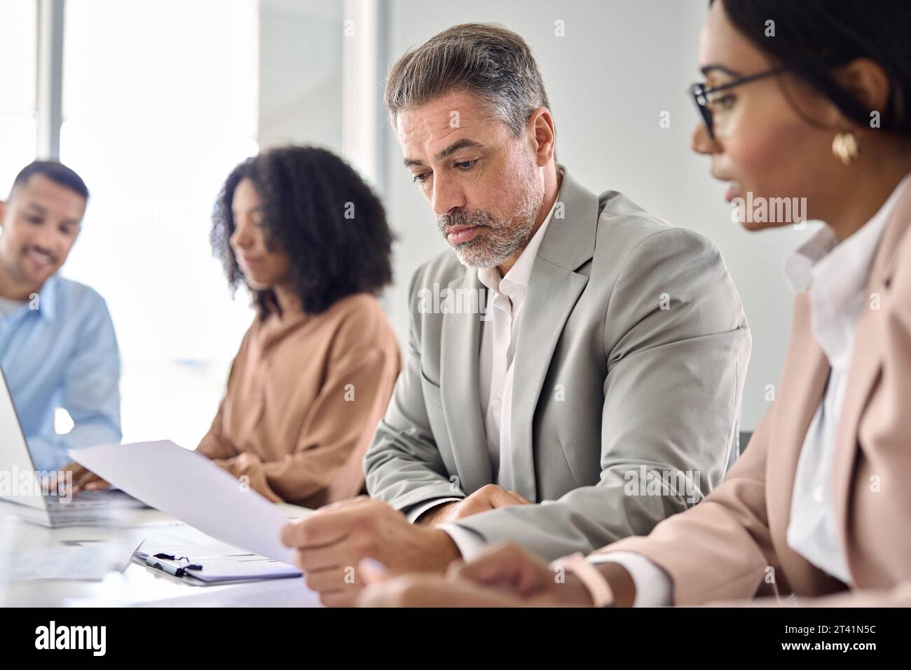 Serious business man checking law document at legal advice meeting ...