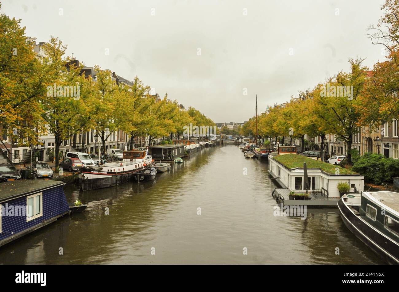 Boat houses on river in Amsterdam Stock Photo - Alamy