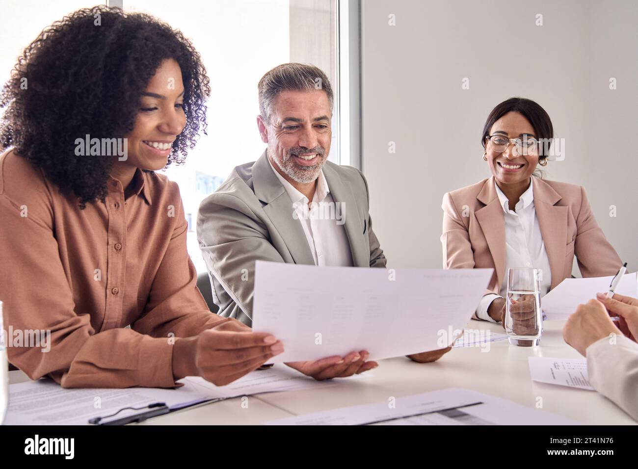 Happy diverse executive business people checking document at meeting in office Stock Photo - Alamy