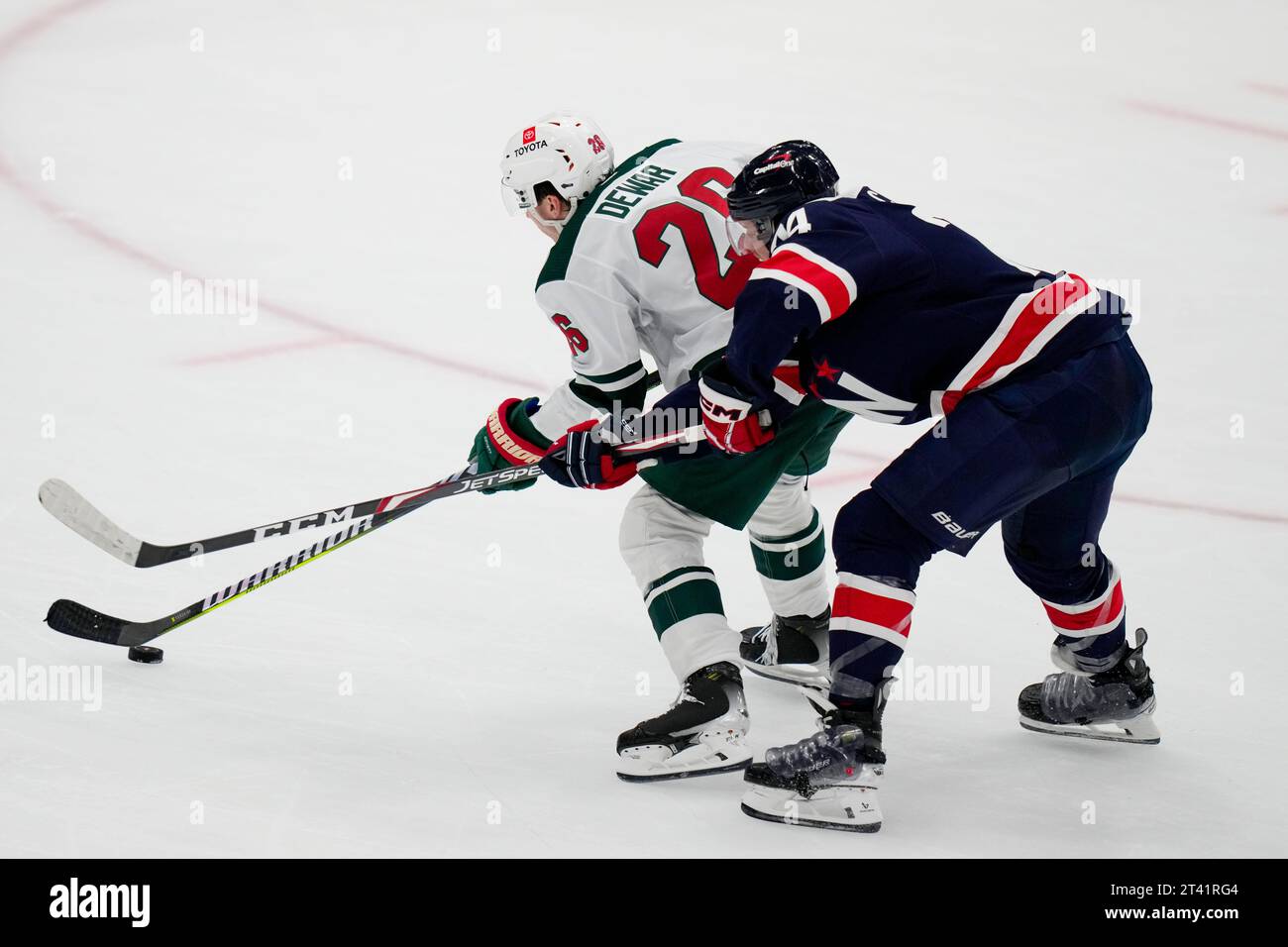 Minnesota Wild center Connor Dewar (26) skates with the puck in front ...