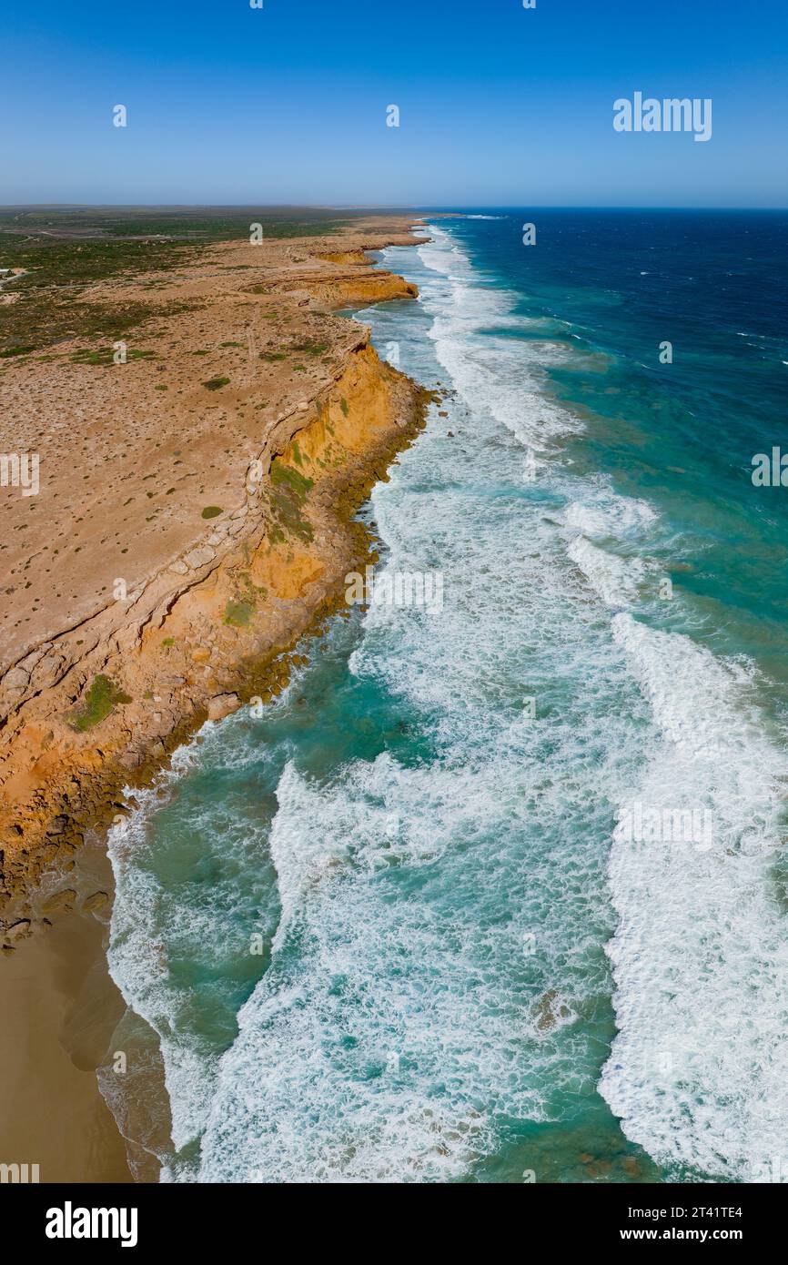Aerial view along rugged cliff tops above large waves at Venus Bay on ...