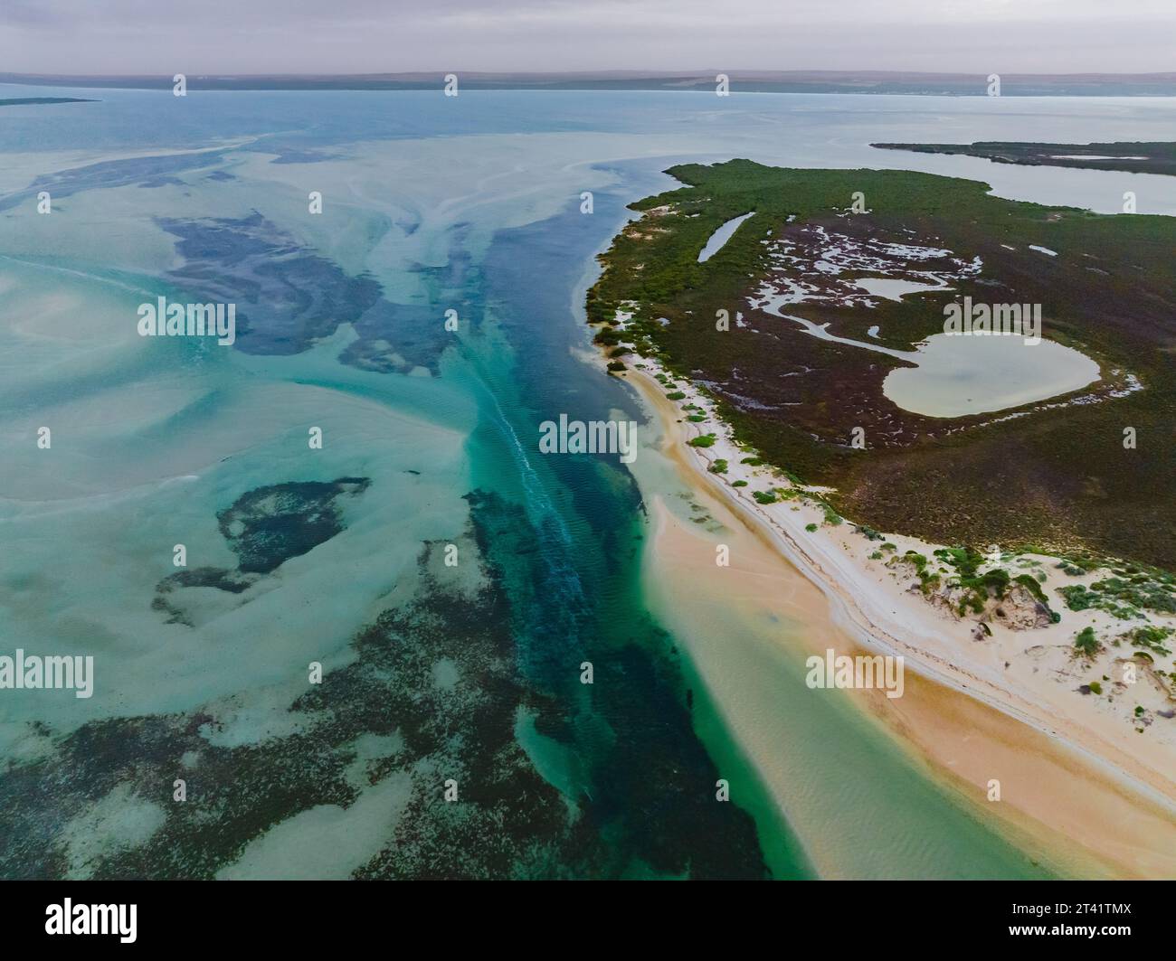 Aerial view of islands and reefs surrounded by channels of deep blue ...