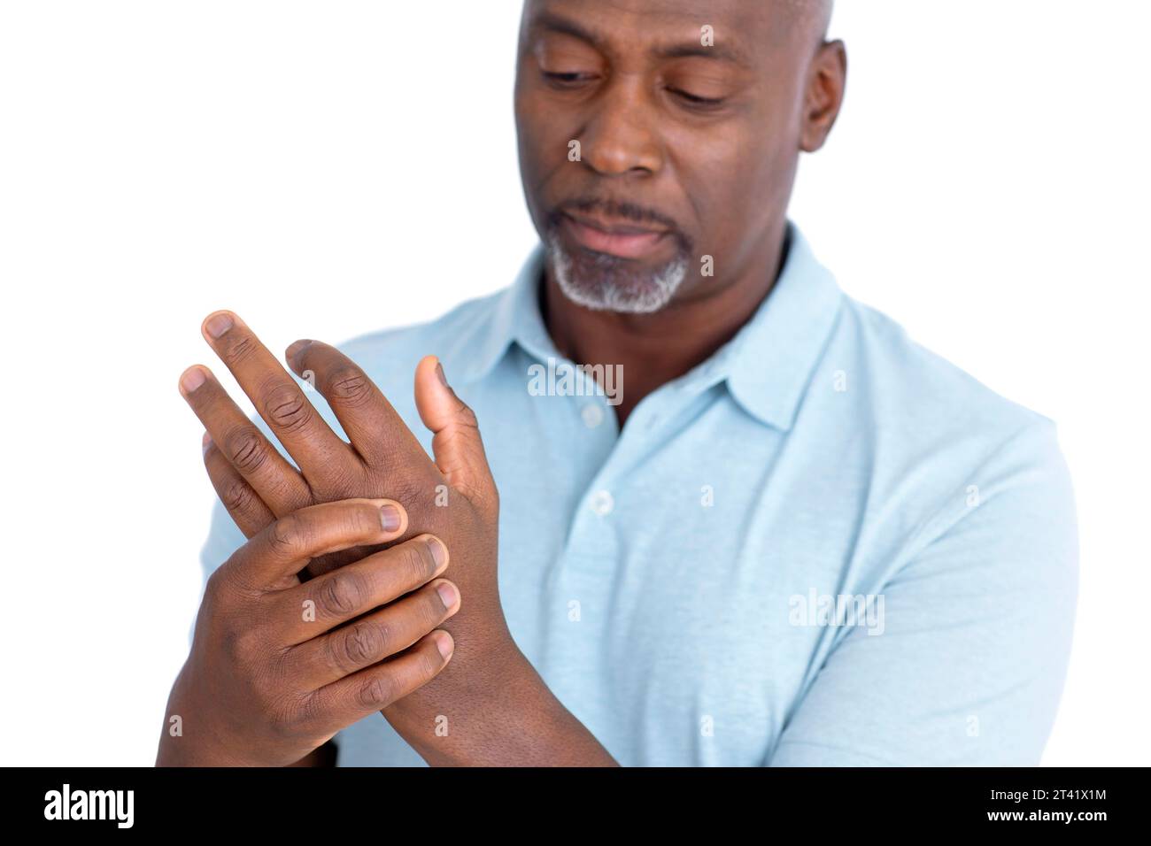 Man holding his painful hand Stock Photo - Alamy