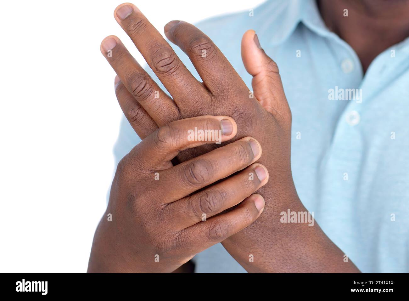 Man holding his painful hand Stock Photo - Alamy