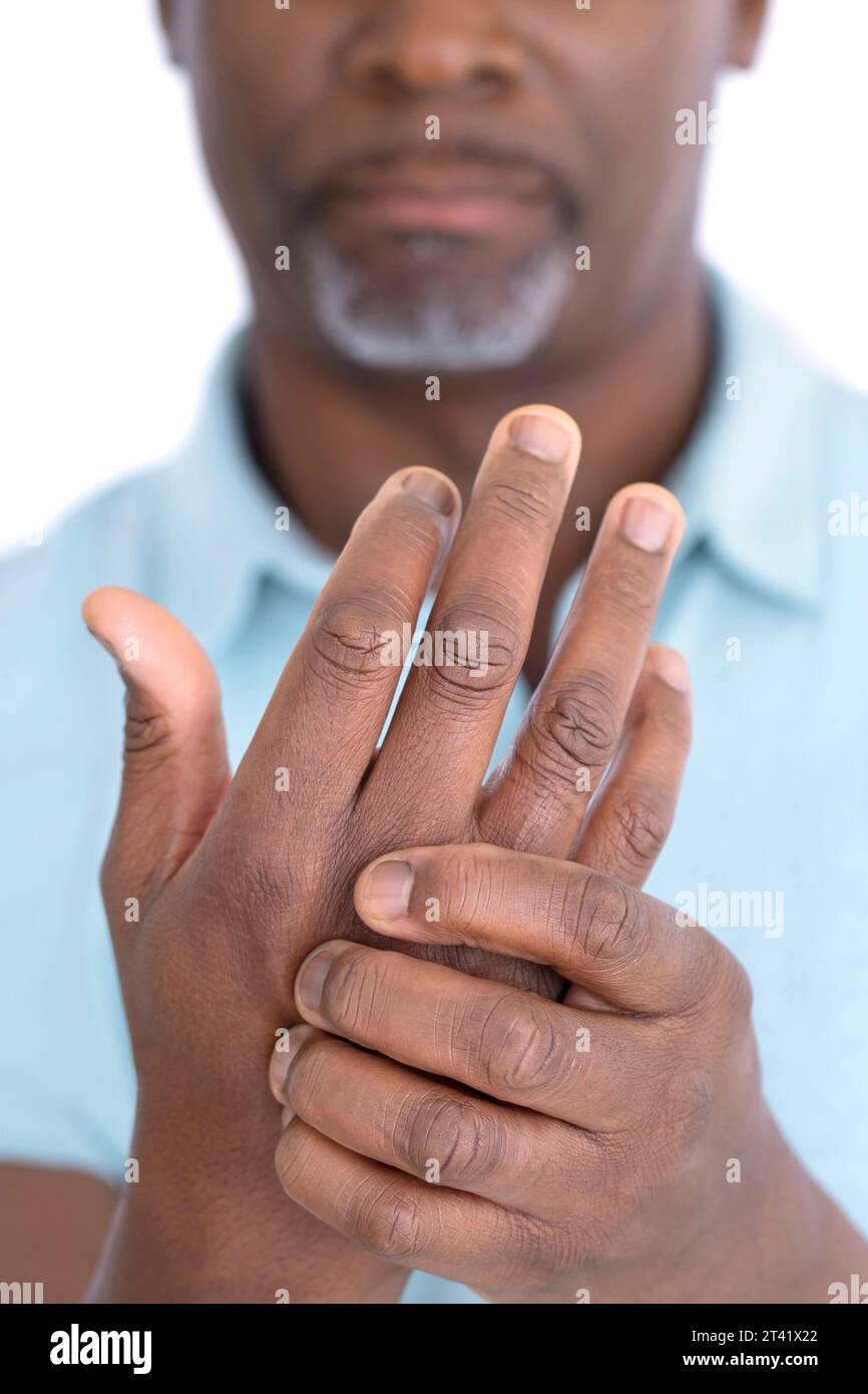 Man holding his painful hand Stock Photo - Alamy