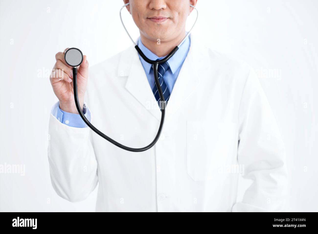 Doctor using stethoscope Stock Photo - Alamy