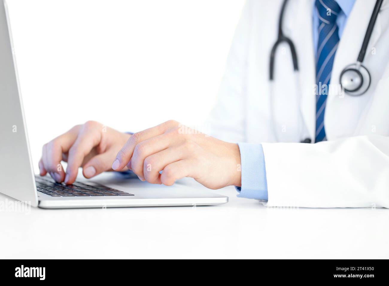 Doctor typing on a laptop Stock Photo - Alamy