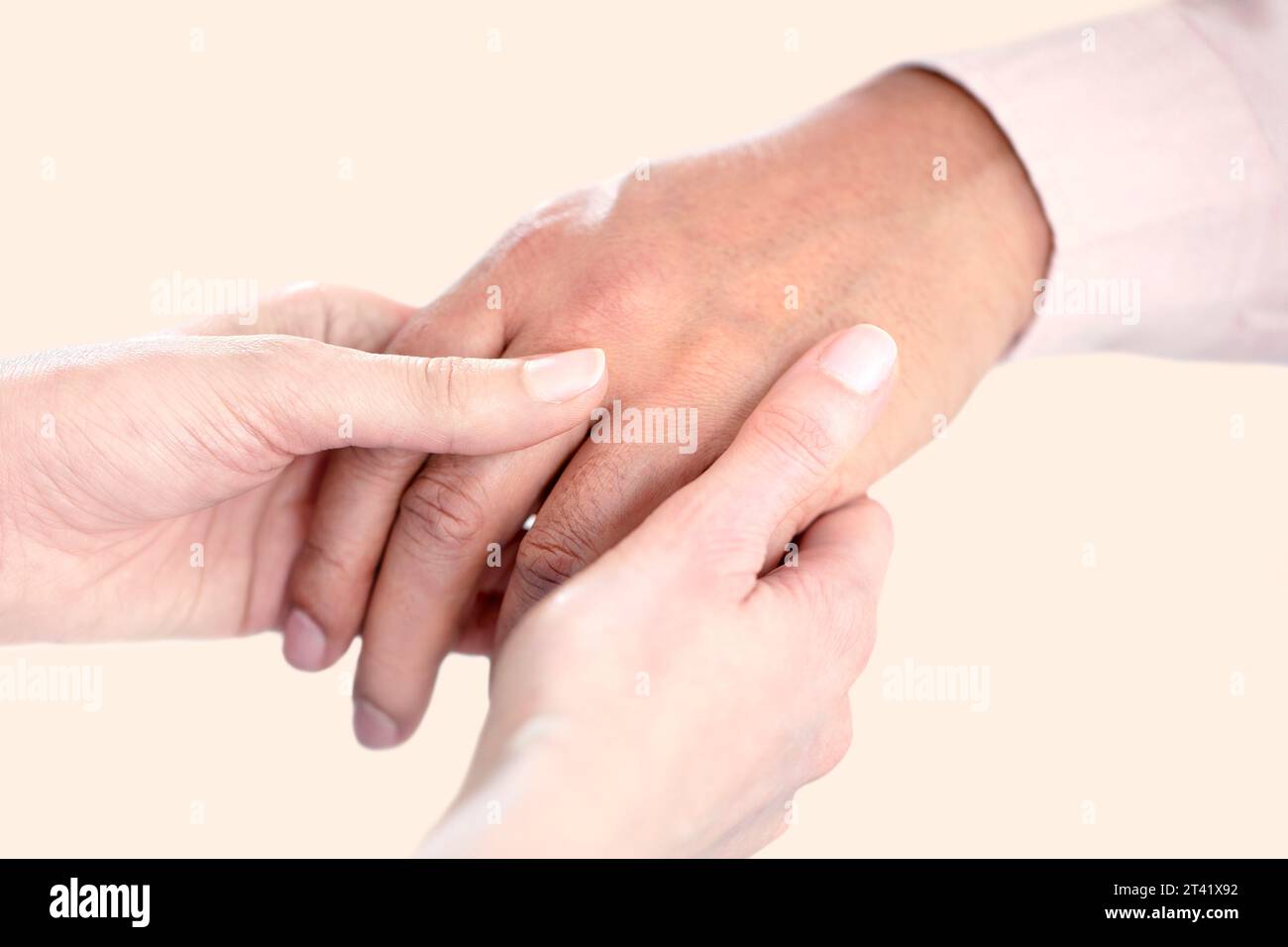 Doctor checking man's hand Stock Photo - Alamy