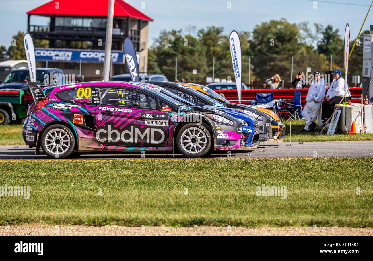 A vibrant image of a car race, featuring multiple cars racing around ...