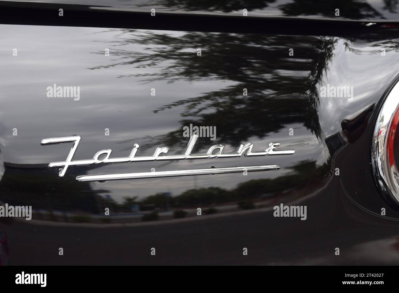 A high-resolution close-up shot of the tail lights of a black Fairlane ...