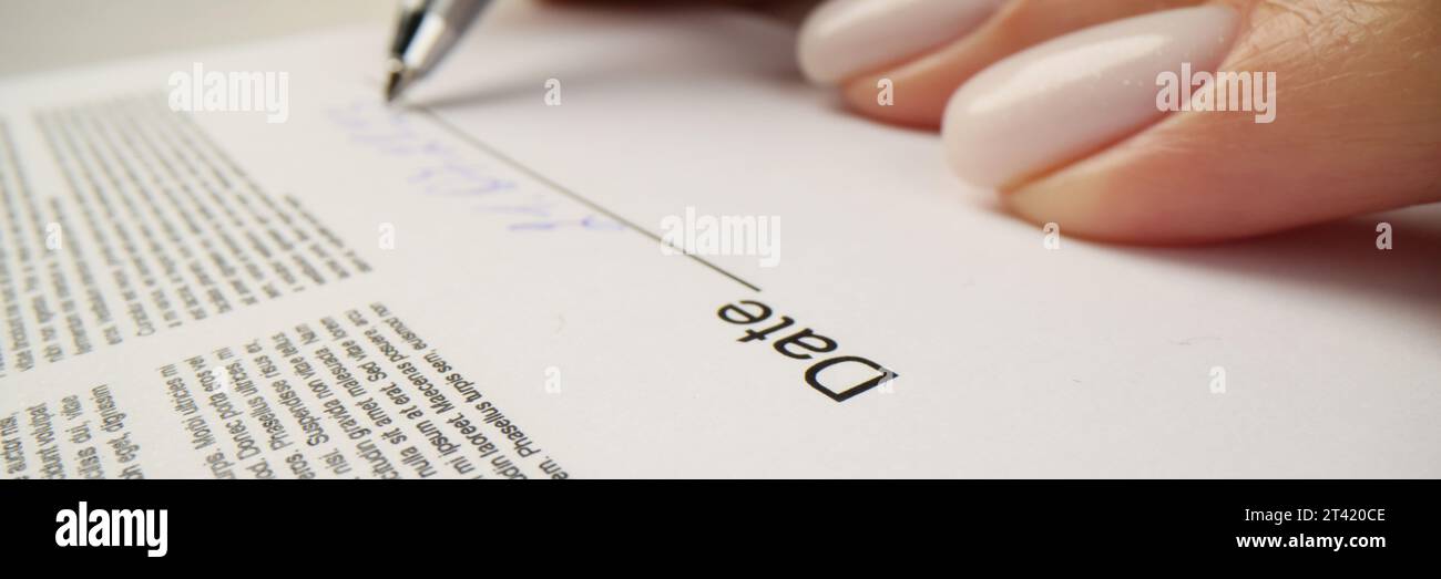 Woman writes date above line after signing contract papers Stock Photo ...