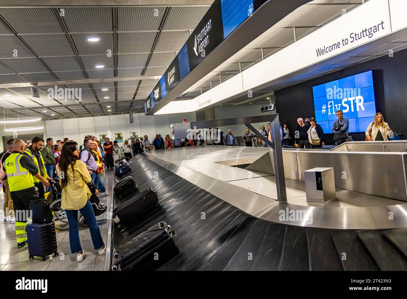 Baggage carousel at the airport, baggage claim, travellers waiting for ...