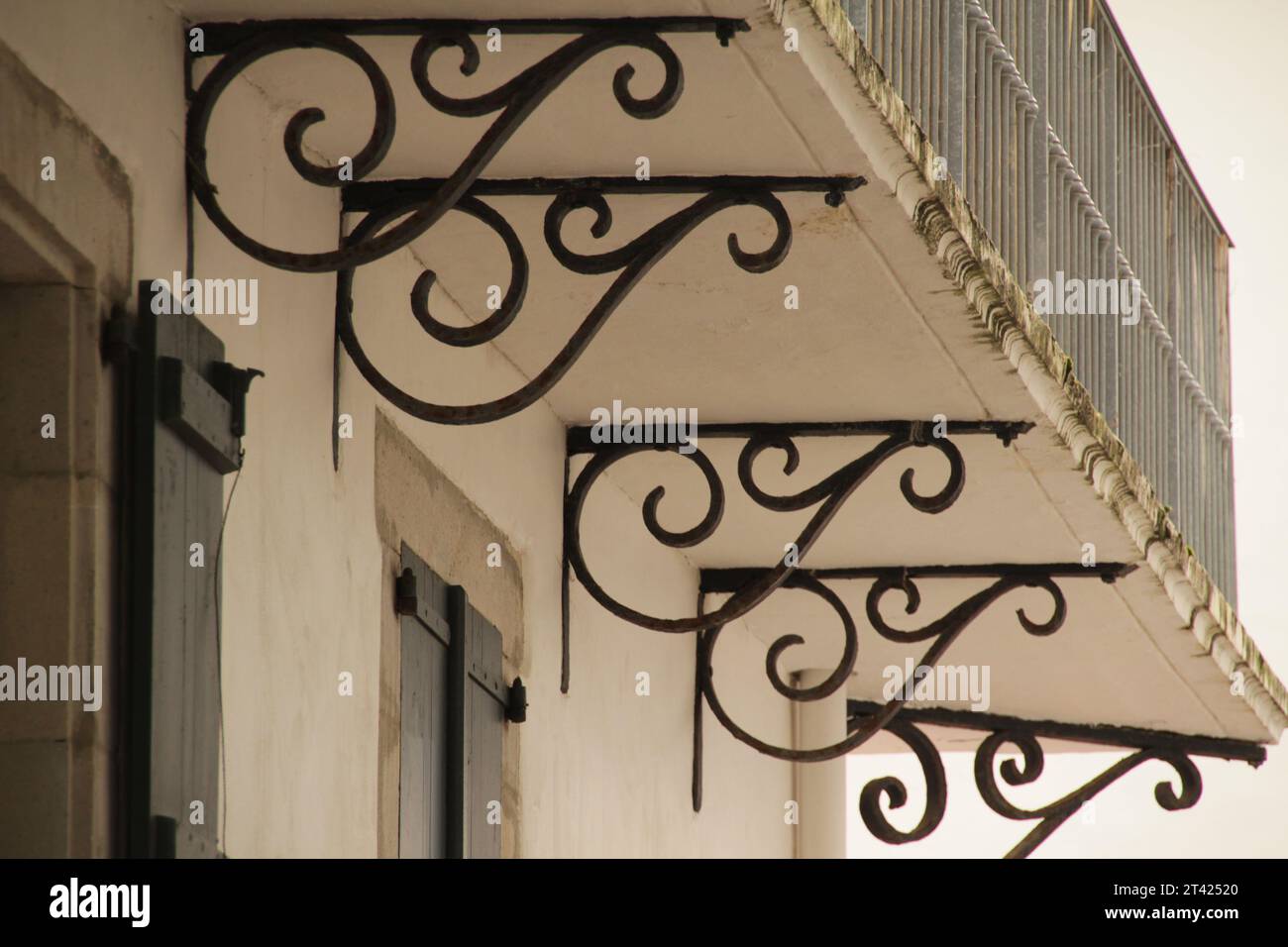 A stunning perspective of a building with decorative ironwork brackets ...