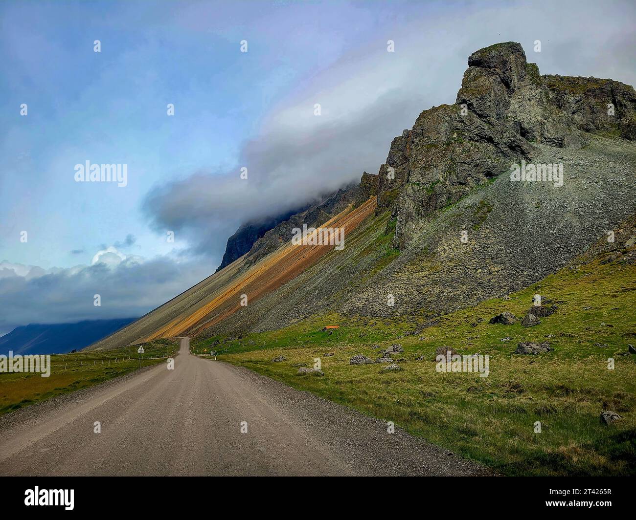 A scenic view of a peaceful country road winding through an open field ...