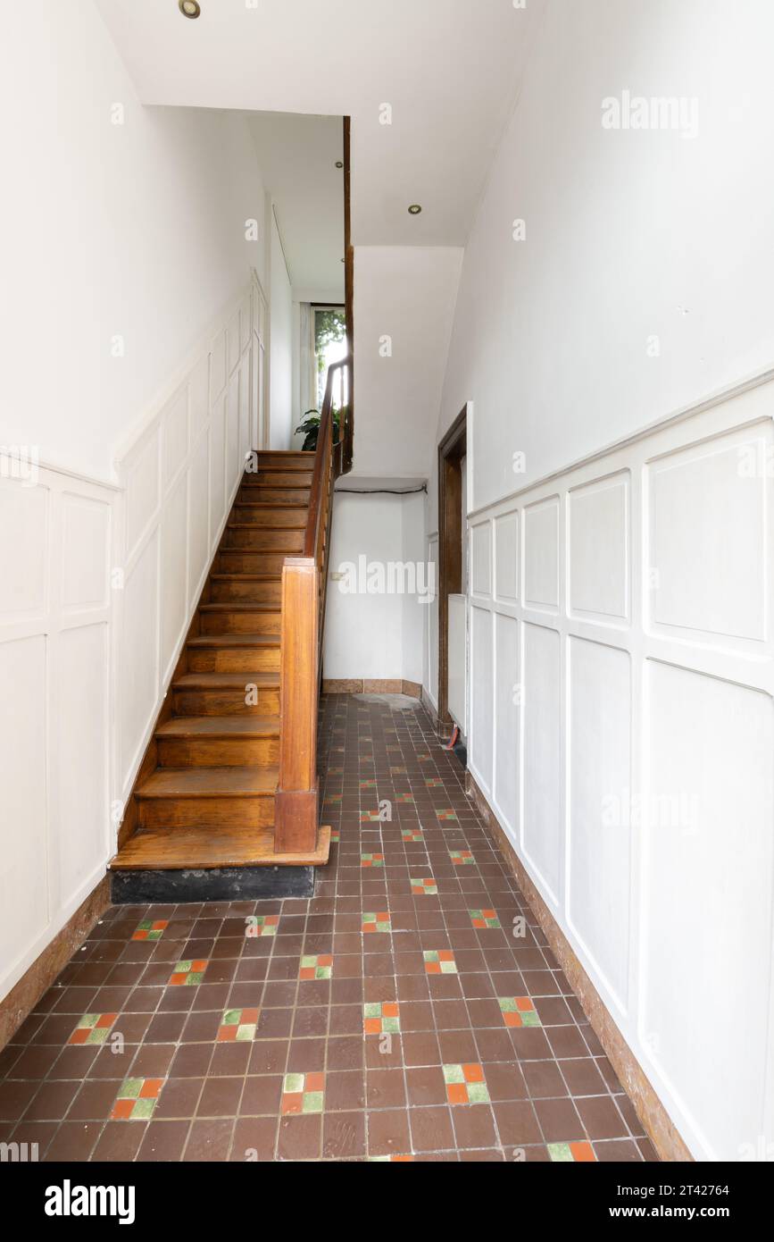 A contemporary hallway featuring a checkered tile floor in shades of red and white Stock Photo ...