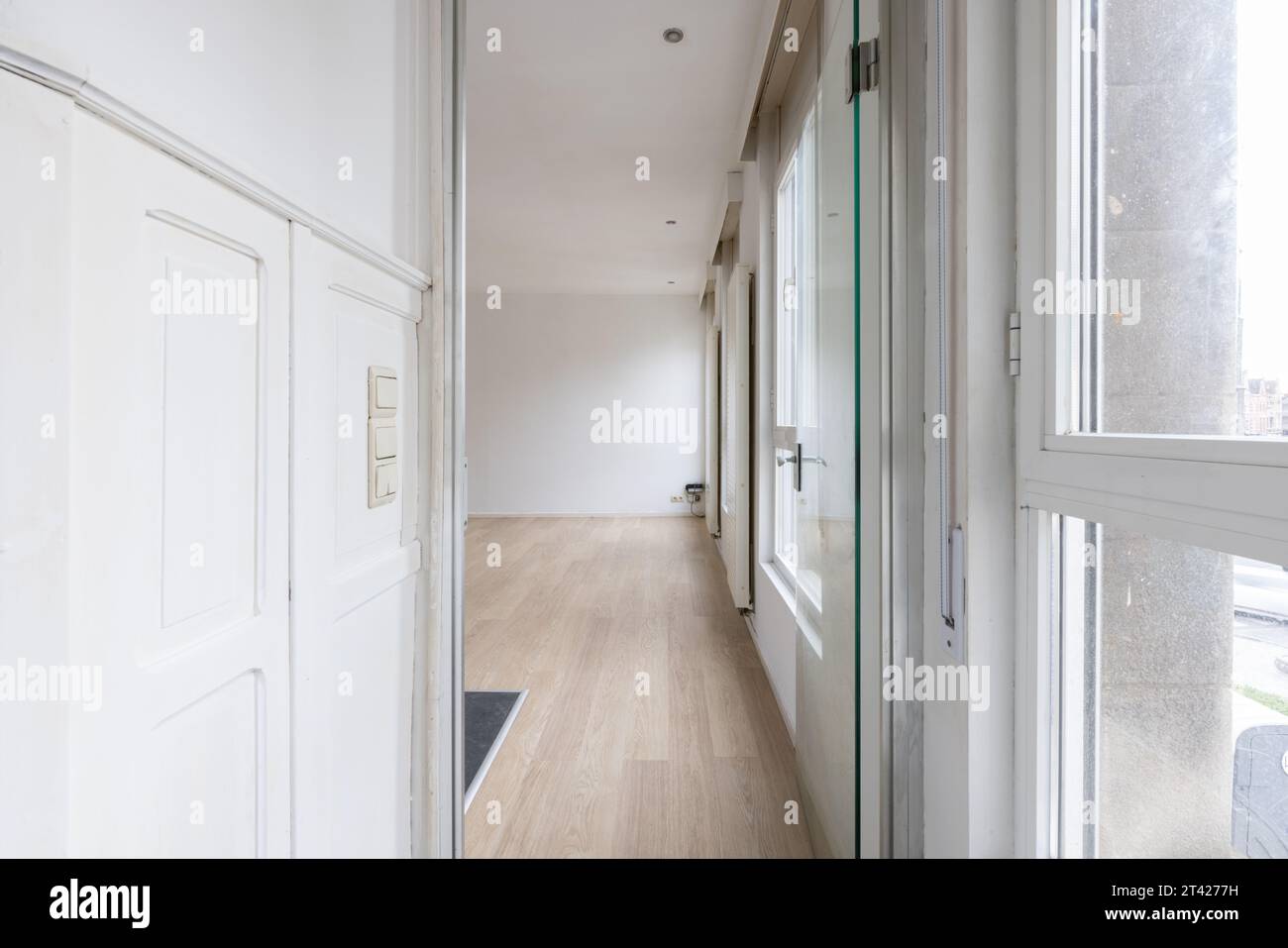 Interior view of a bright and airy room with hardwood floors and a ...