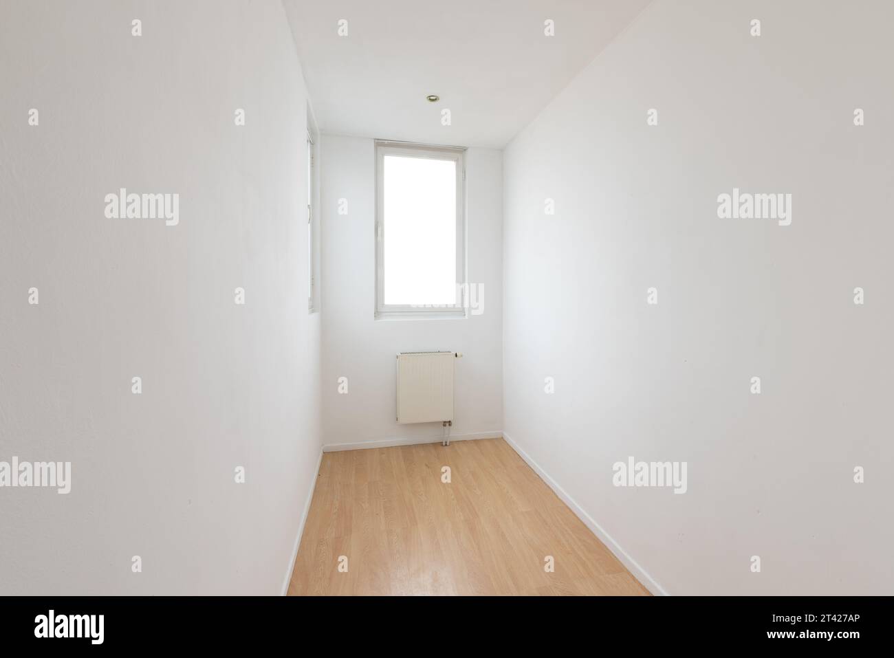 A cozy, white-walled interior boasting wooden flooring and a ...
