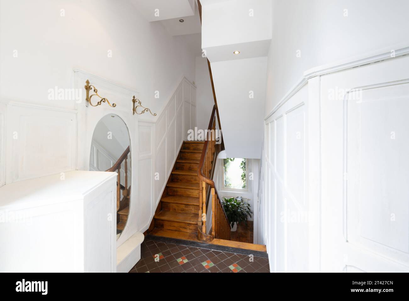 A well-lit hallway in a white interior house setting Stock Photo - Alamy