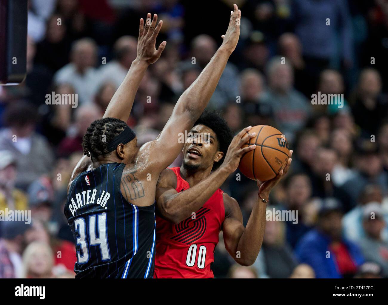 Portland Trail Blazers guard Scoot Henderson, right, prepares to shoot ...