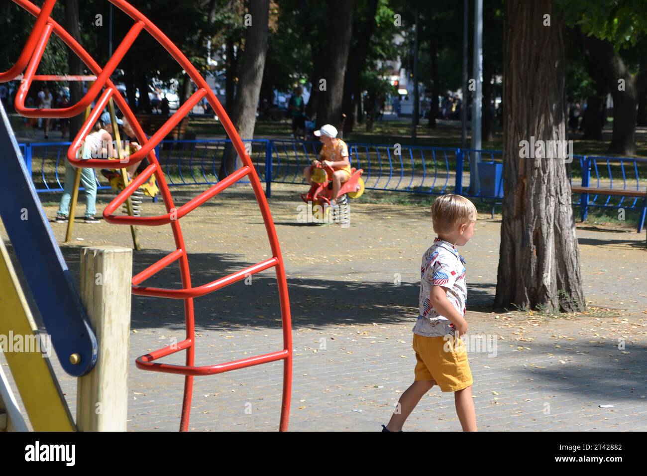 Little children run around and play in the playground. Game center for ...