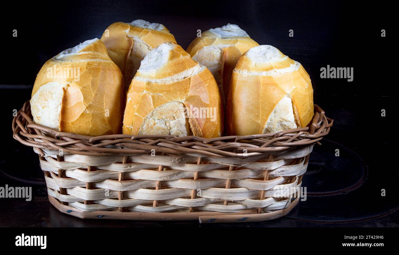 A basket of freshly baked bread sits atop a kitchen counter next to an ...