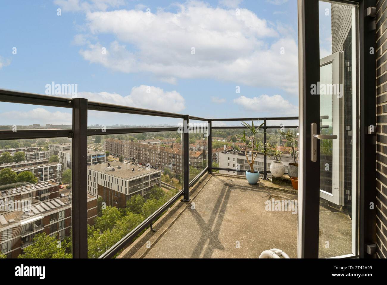 a balcony with a view of the city from it's window sing out to the ...