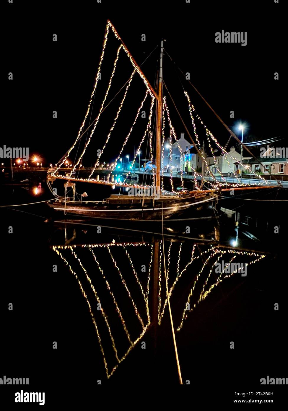 Two large boats in the middle of a tranquil lake illuminated by a ...
