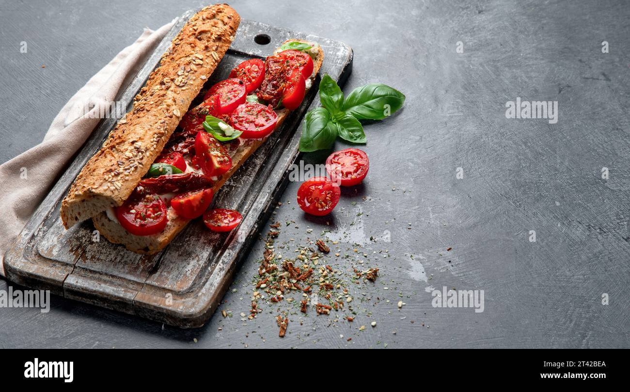 Fresh baguette with Caprese. Delicious sandwich with with tomatoes and mozzarella cheese with ...