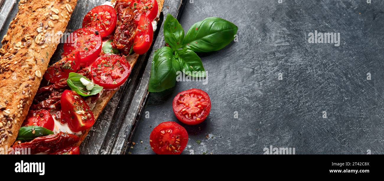 Fresh baguette with Caprese. Delicious sandwich with with tomatoes and mozzarella cheese with ...