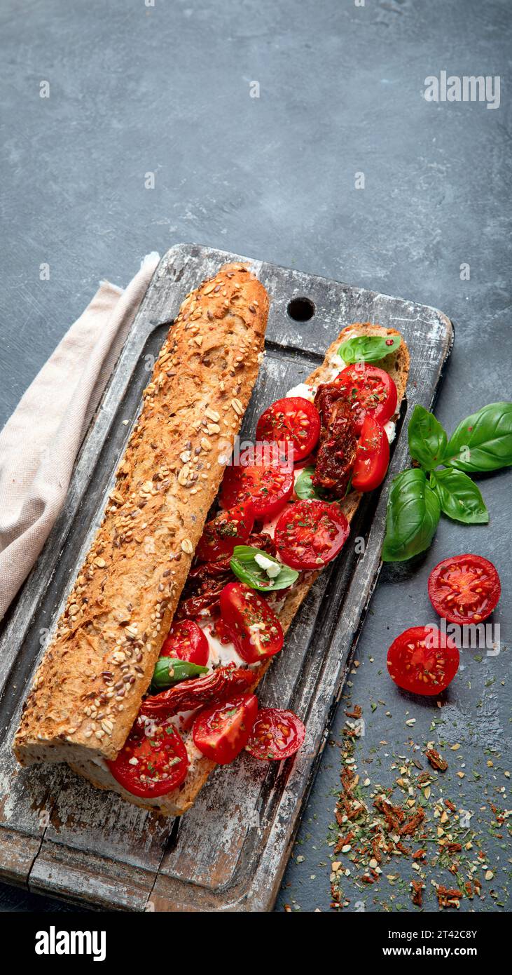 Fresh baguette with Caprese. Delicious sandwich with with tomatoes and mozzarella cheese with ...