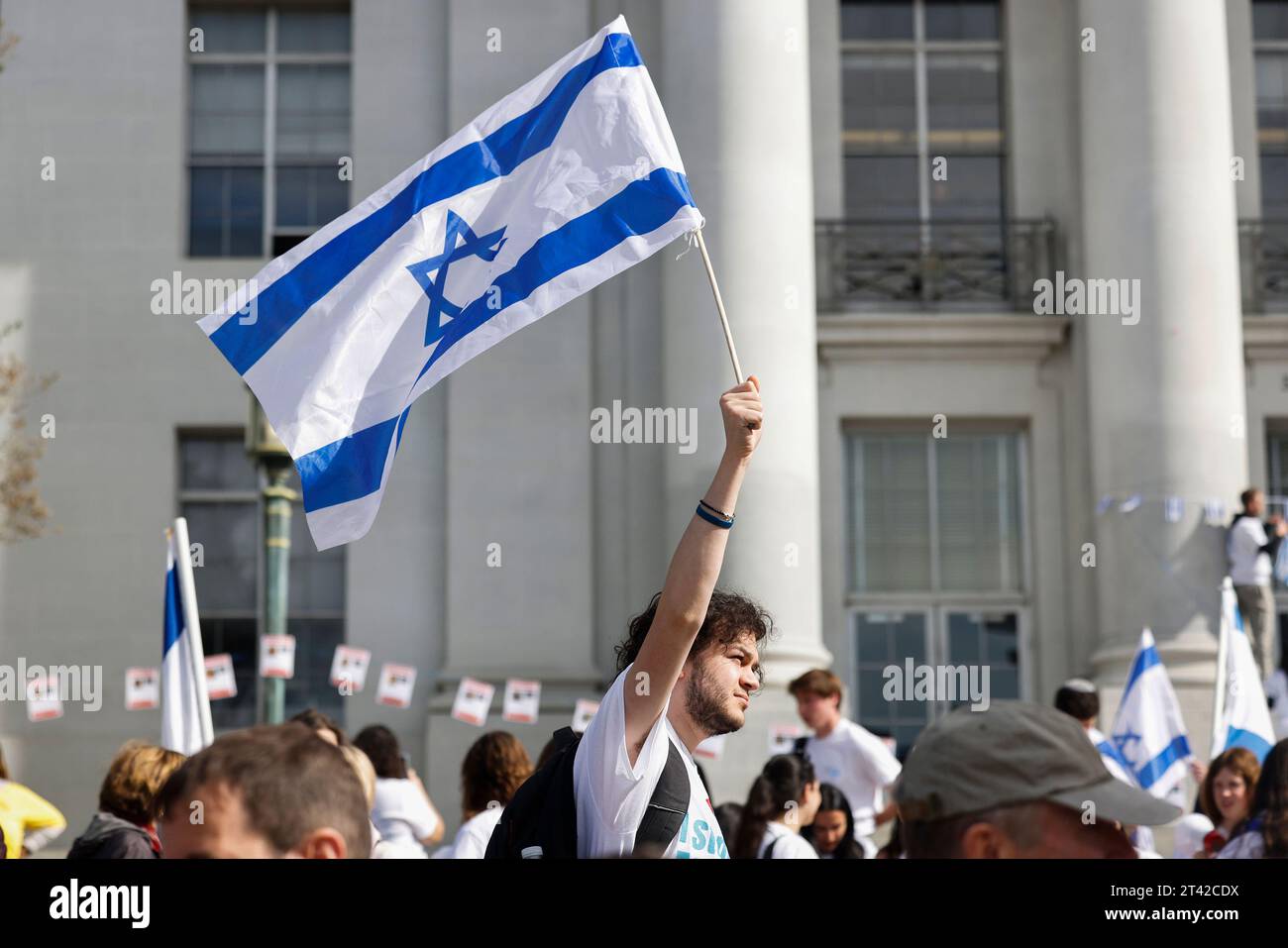 Aiden Bernato carries an Israeli flag during a rally held in support of ...