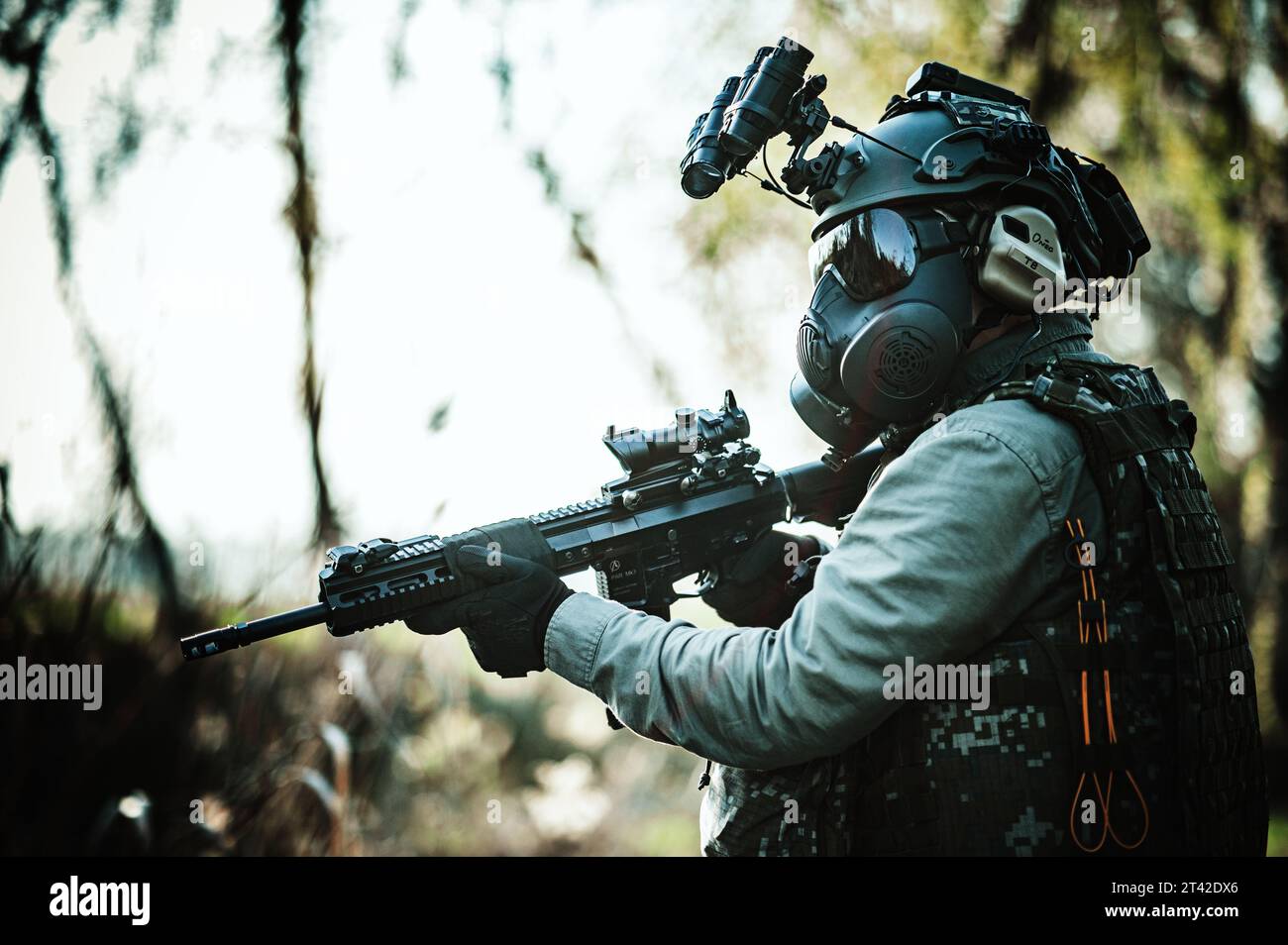 A man in gas mask in full military gear is pictured, wearing a helmet ...