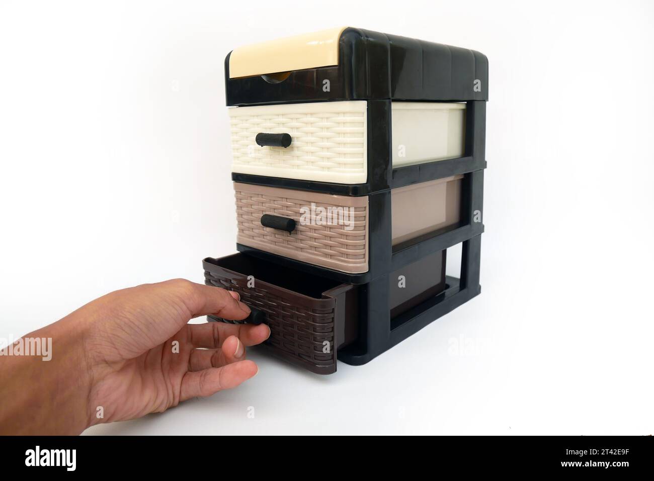 Man's hand is opening a pastel cream office storage plastic box on an ...