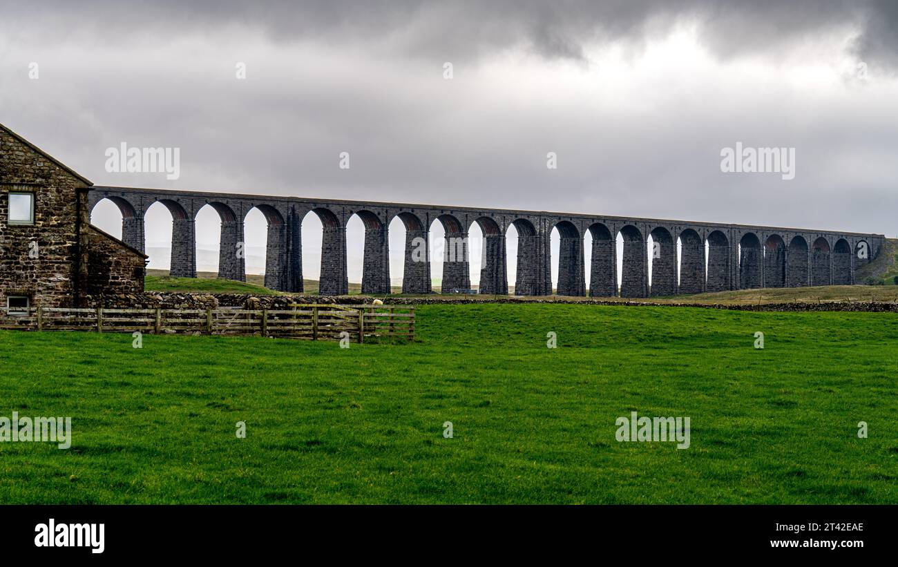 A wooden bridge with an arched structure, arching over a steep cliff in ...