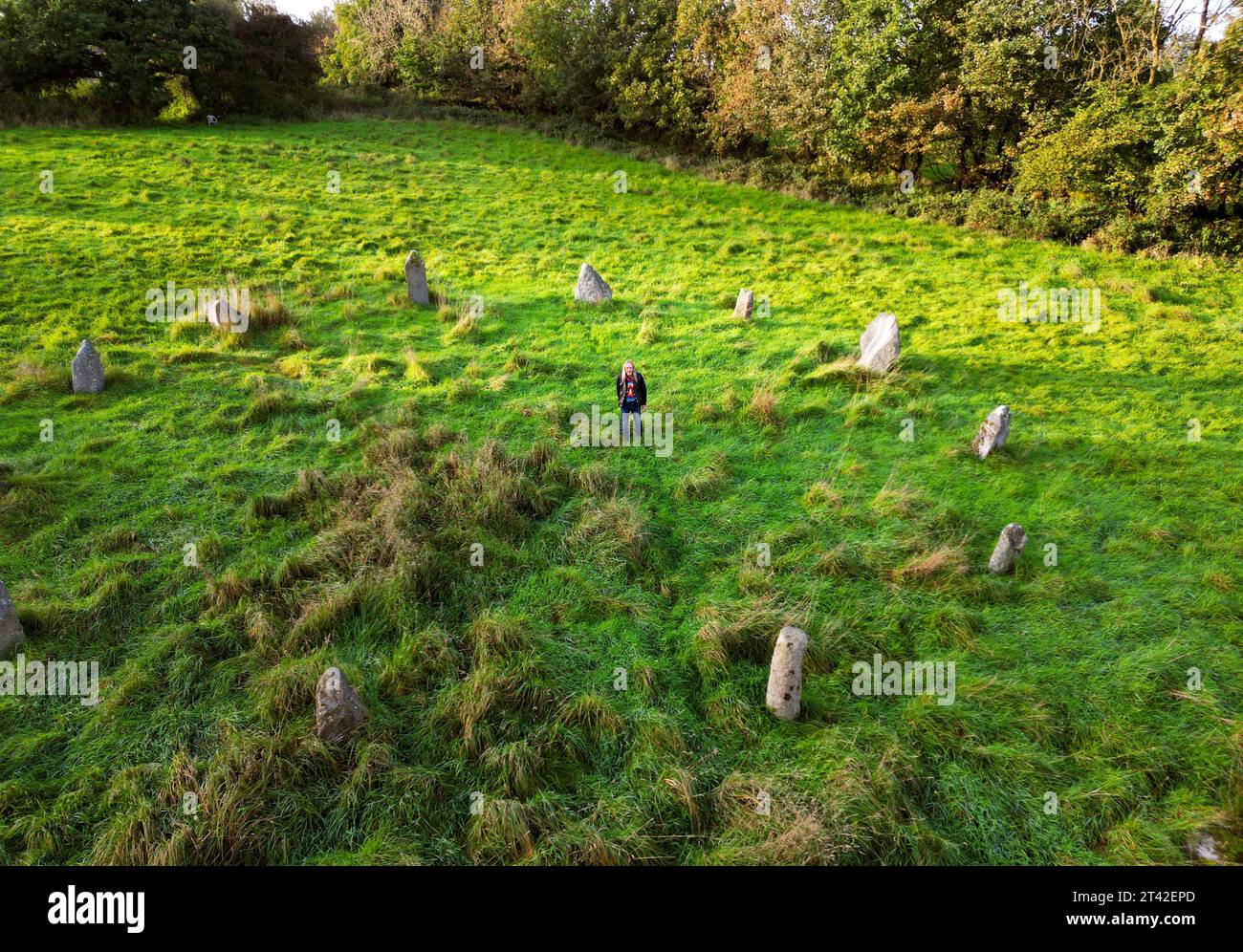 A person in the center of a stone circle of rocks in a secret location ...