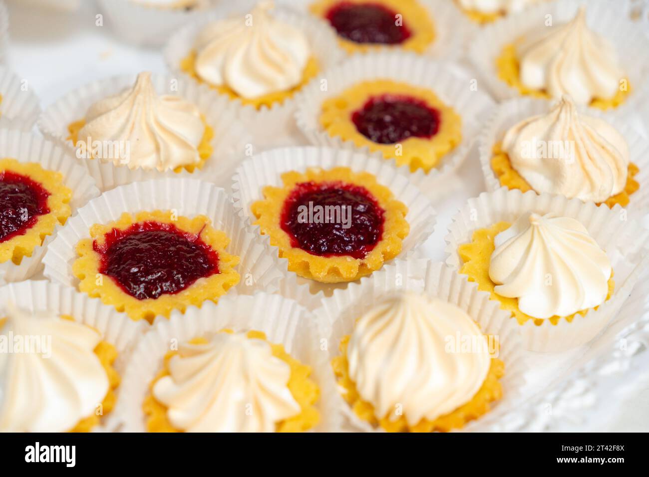 An overhead view of a plate of colorful desserts surrounded by other ...