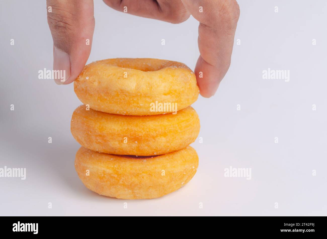 Hand with Donuts cake bakery sprinkled with sugar on white background ...