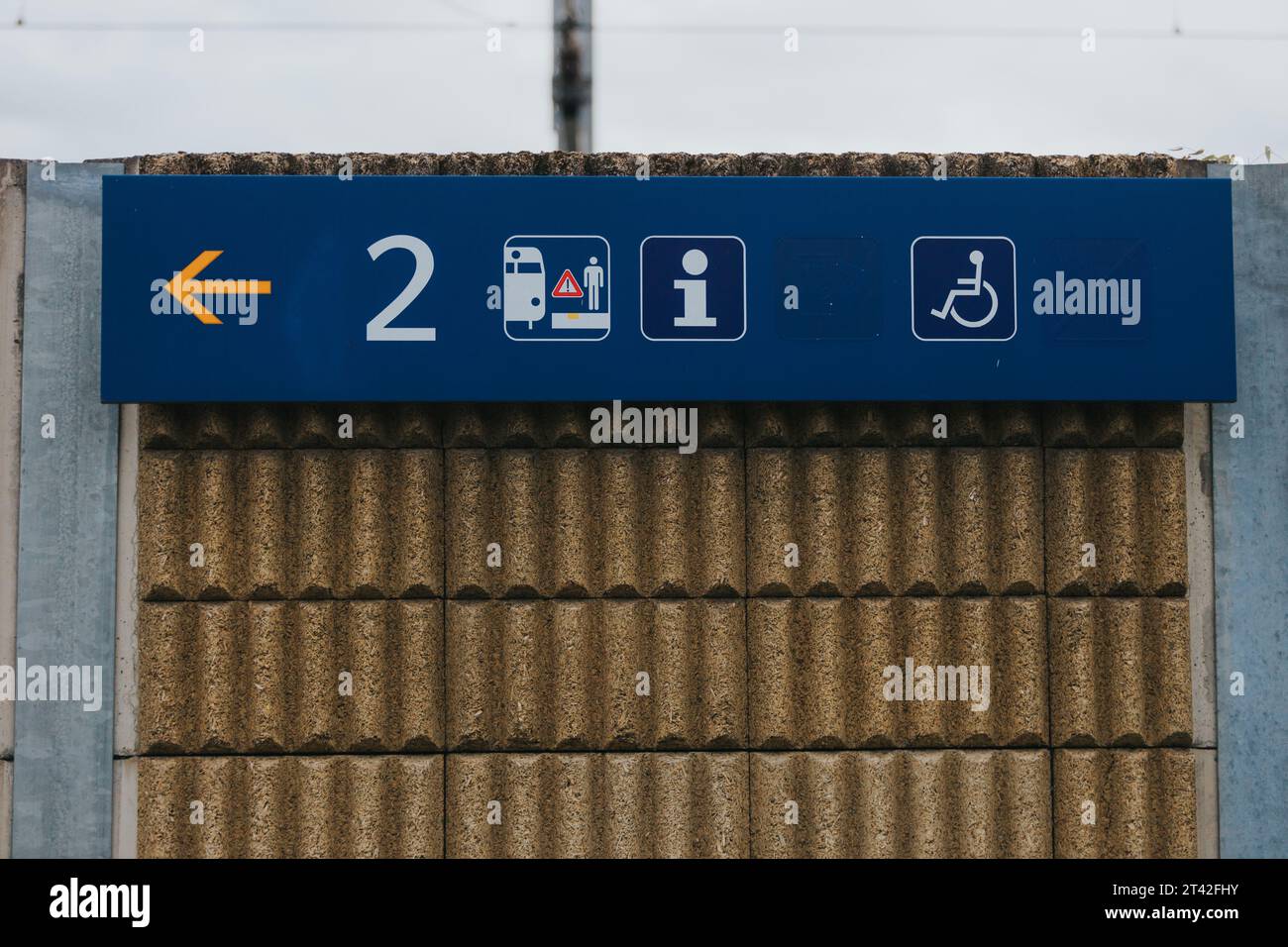 A blue sign with a white number two on it situated outside of a ...