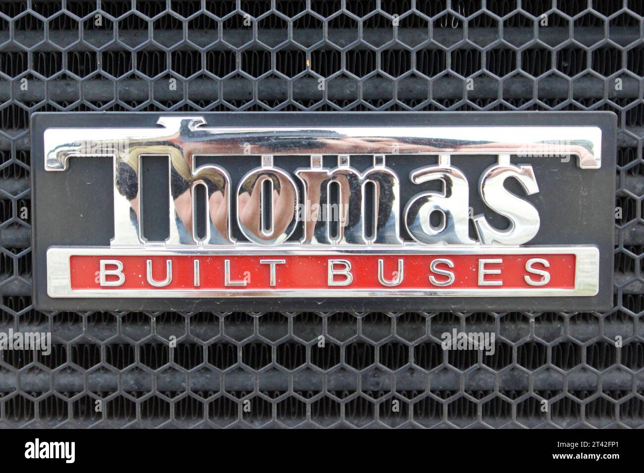 A white emblem featuring the name 'Thomass Built Buses' is prominently ...