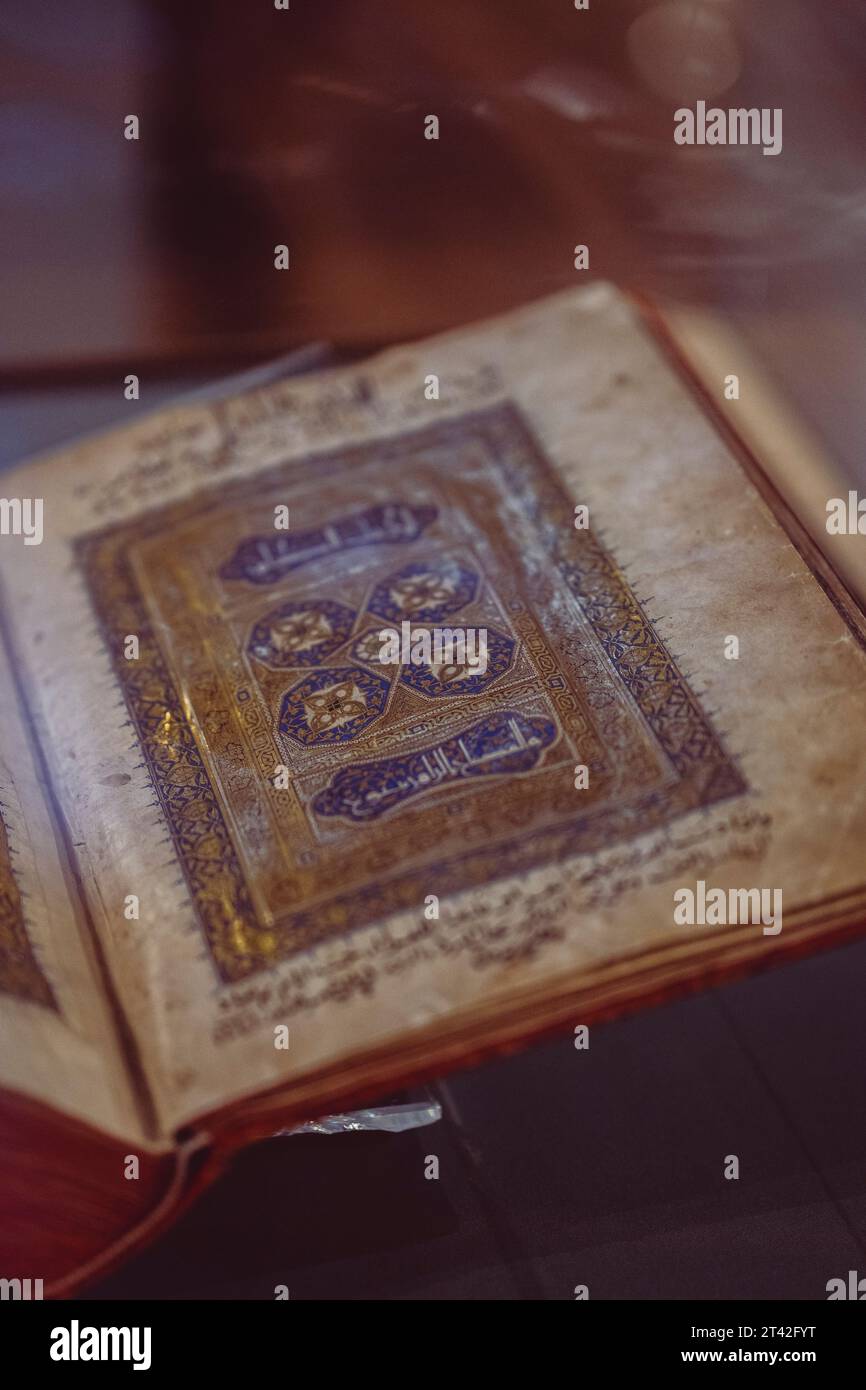 A closeup of Ancient Christian Bible, written in Arabic with a blurry ...
