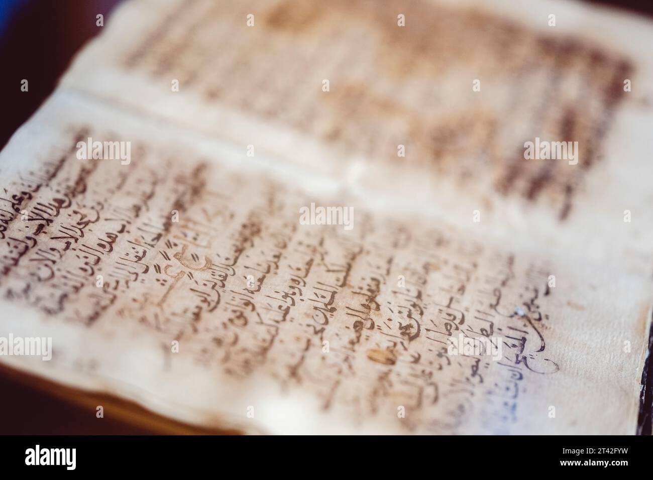 A closeup of Ancient Christian Bible, written in Arabic with a blurry ...