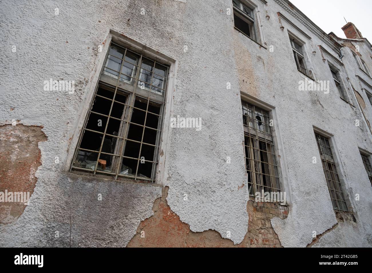 From below of abandoned building with broken glass windows and ...