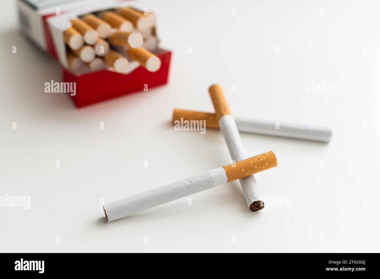 cigarettes form as three crosses on white background Stock Photo - Alamy