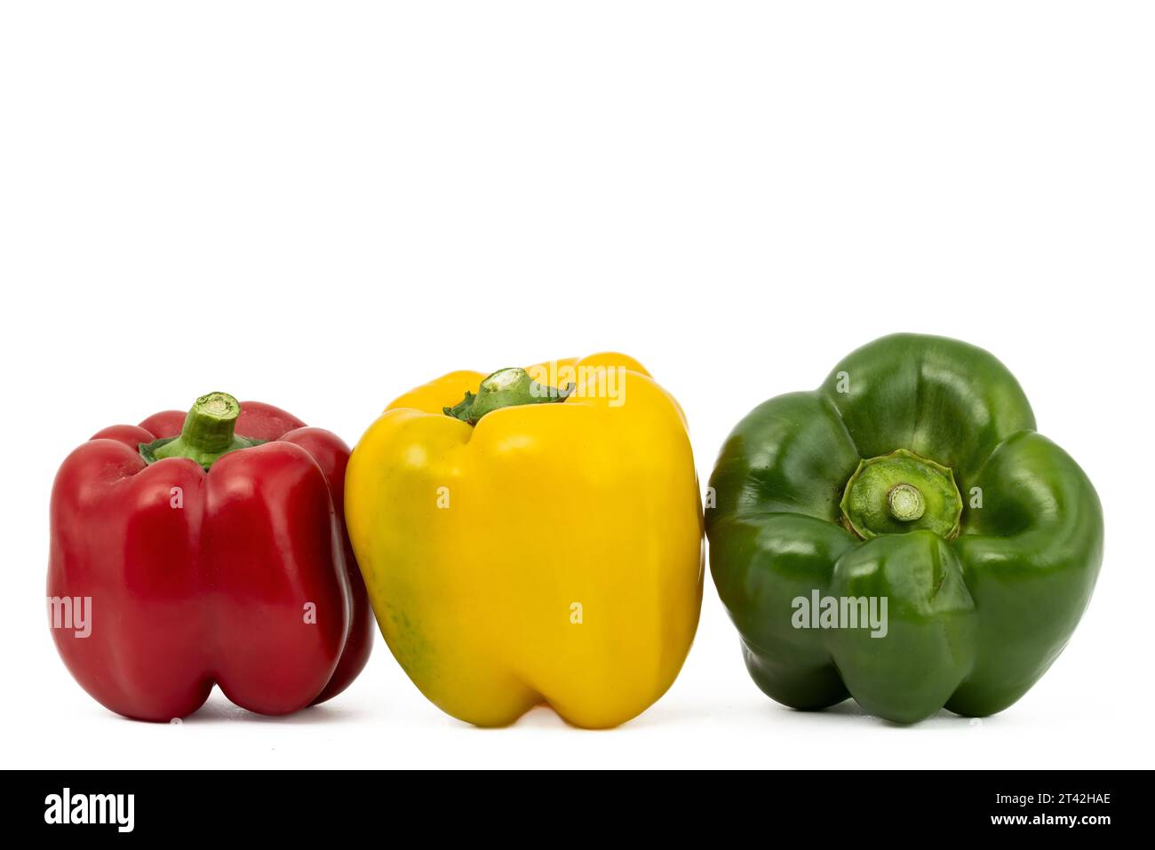 A vibrant selection of peppers of assorted colors lined up against a ...