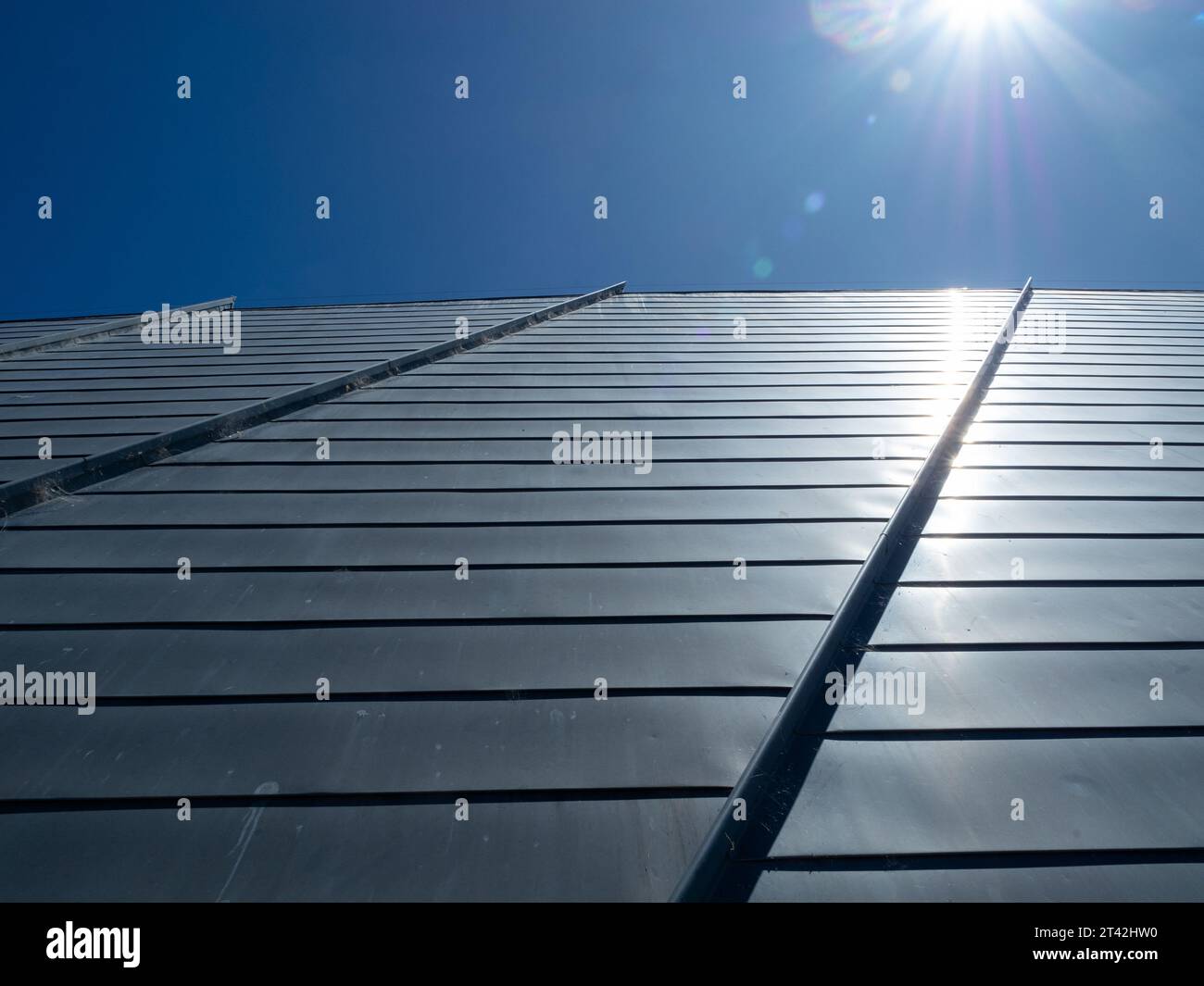 Sideways roof, looking upwards towards the sky and sun, from an odd ...