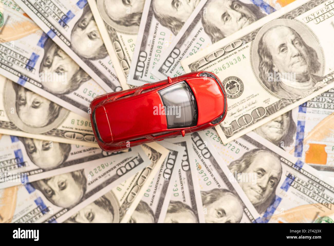 American dollars and miniature car model on white wooden background ...